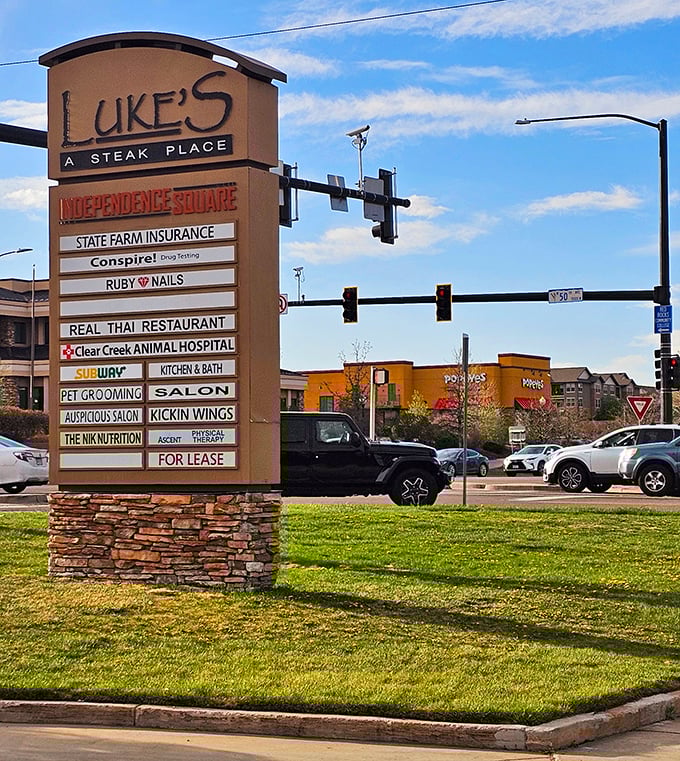 Luke's takes top billing at Independence Square, standing proud among everyday businesses. Even the Colorado sky seems to celebrate this culinary landmark.