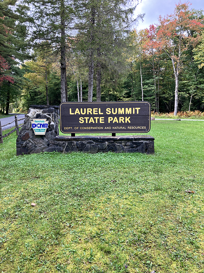 The welcoming sign that promises exactly what it delivers: a summit experience worth every mile of the journey.
