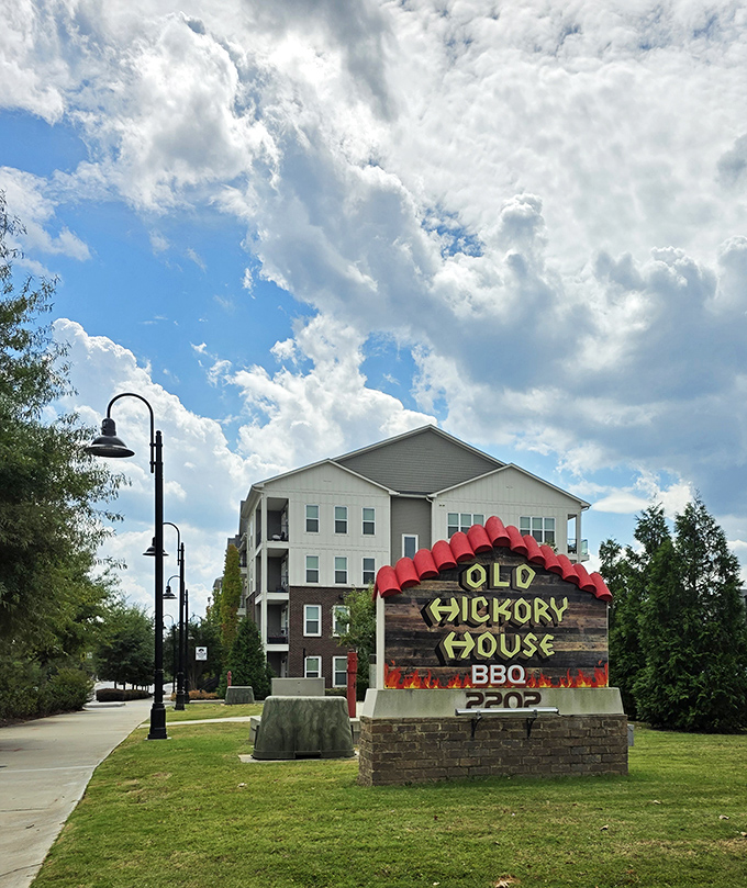 The roadside sign stands as a barbecue lighthouse, guiding hungry travelers to a taste of Georgia that's worth pulling over for.