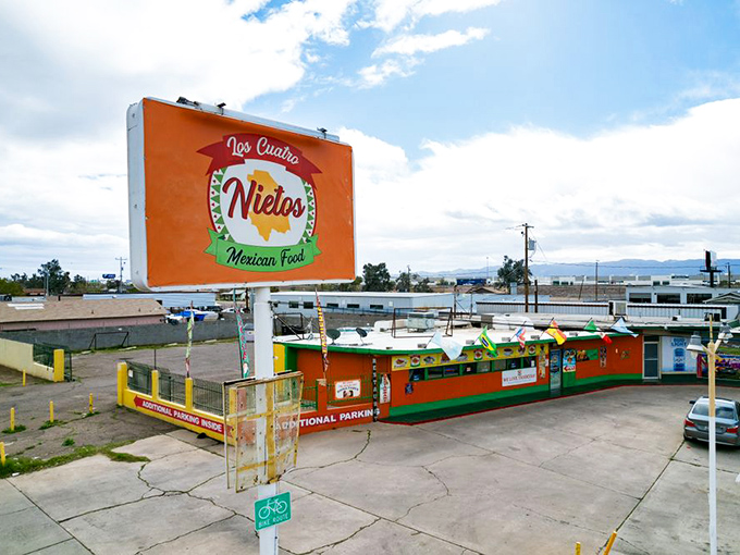 From above, Los Cuatro Nietos stands out like a colorful oasis in the desert, its orange sign a beacon for hungry travelers.