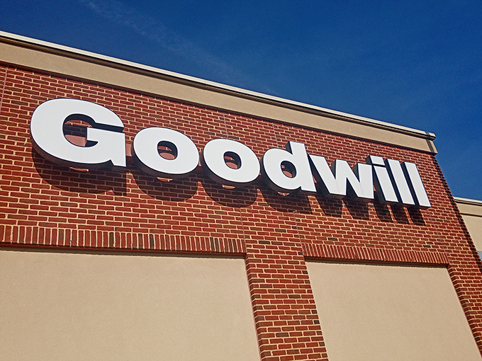 The iconic Goodwill sign against blue sky&mdash;where "retail therapy" meets "doing good" in perfect, budget-friendly harmony.