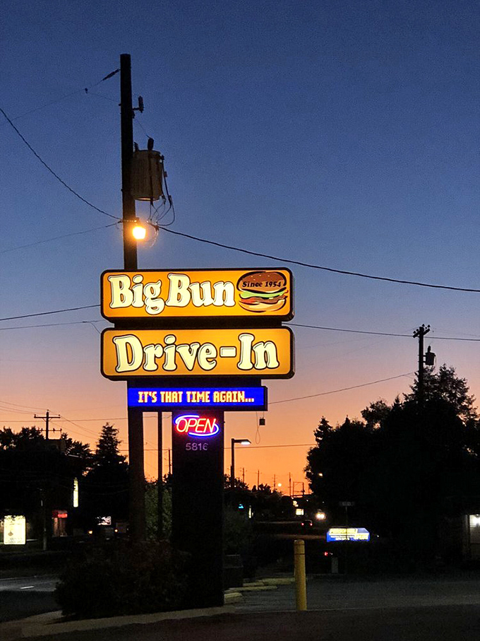 As dusk falls, the illuminated Big Bun sign glows like a lighthouse guiding hungry travelers to safe harbor. Some beacons guide ships; this one guides appetites.