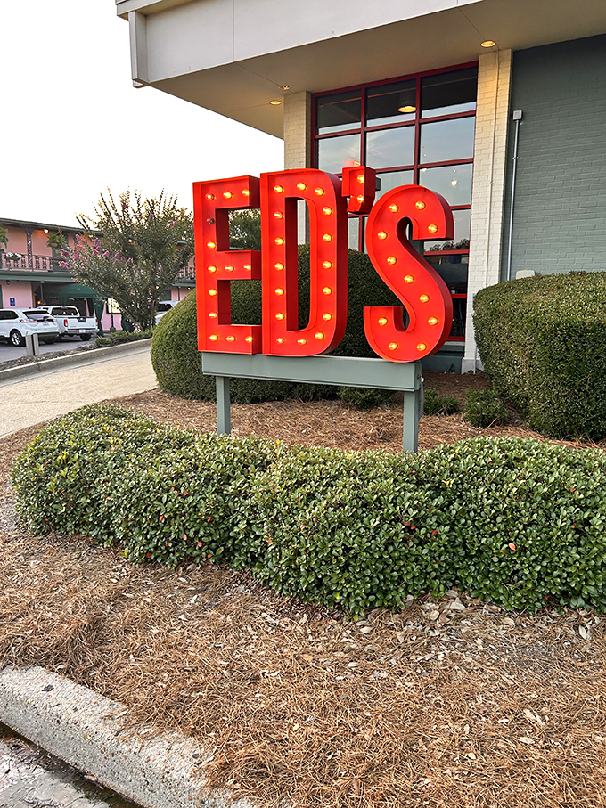 The iconic red "ED'S" sign glows like a burger bat-signal, calling hungry patrons from miles around to answer its meaty siren song.