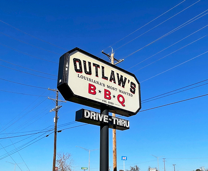 The roadside sign stands tall against the Louisiana sky, a beacon guiding hungry travelers to smoked meat salvation.