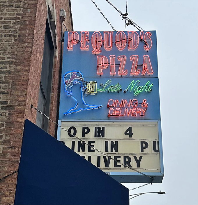 The neon whale sign glows like a lighthouse beacon, guiding hungry souls to the promised land of caramelized crust glory.