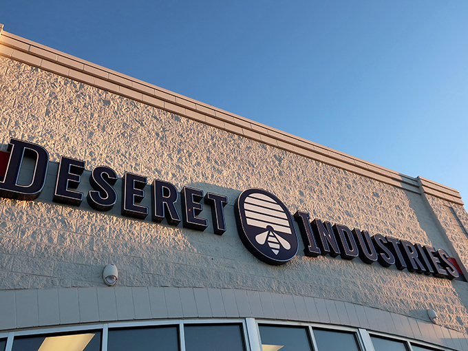 The Deseret Industries sign glows in the Idaho sunshine, promising adventures in secondhand shopping for those brave enough to enter.