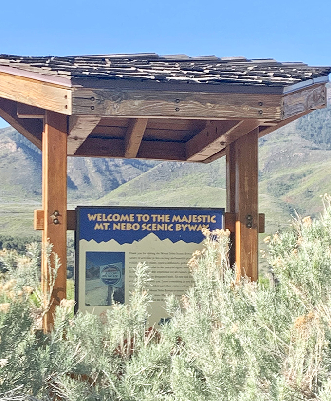 The welcome sign stands like a friendly mountain greeter, slightly weathered but full of promises about the journey ahead.