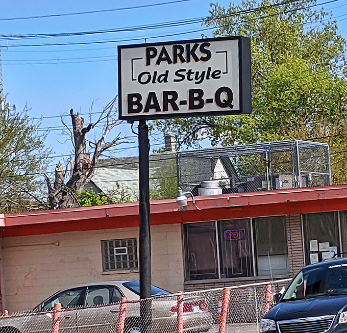 The sign stands as a simple promise: authentic barbecue awaits, no gimmicks required, just bring your appetite and respect.