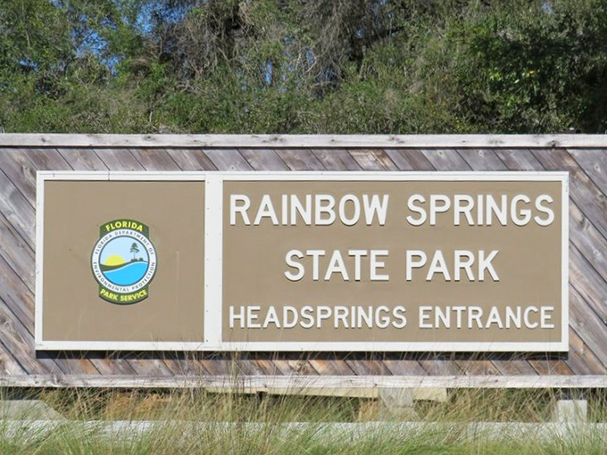 The entrance sign that promises more natural beauty in one park than most states manage in their entire tourism budget.