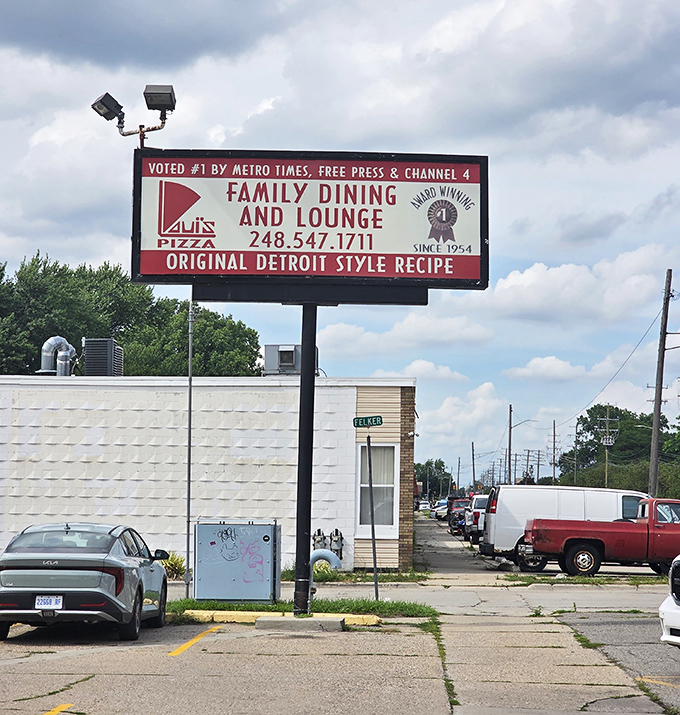 The roadside billboard proudly announces what locals already know: this is Detroit-style pizza royalty, no pretenders allowed.