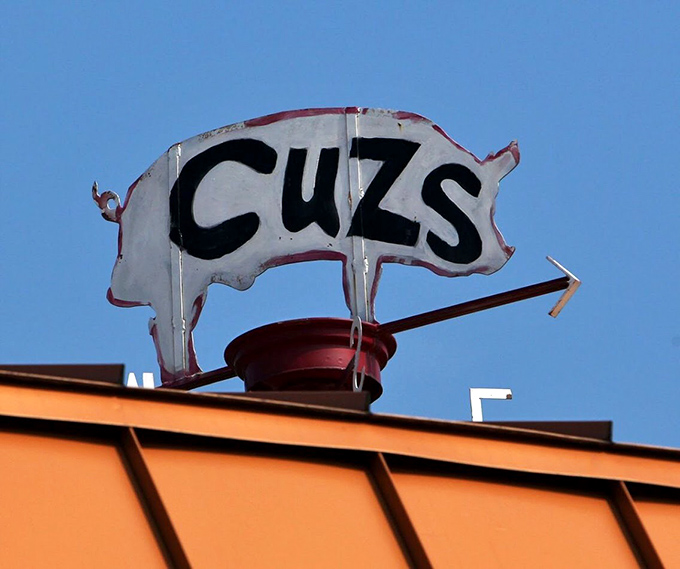 The iconic Cuz's pig sign&mdash;a simple silhouette that has guided hungry travelers like a porcine North Star for generations.