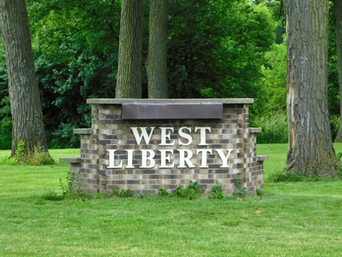 The town's entrance sign, nestled among mature trees, welcomes visitors with understated Midwestern hospitality – no flashy gimmicks needed here.
