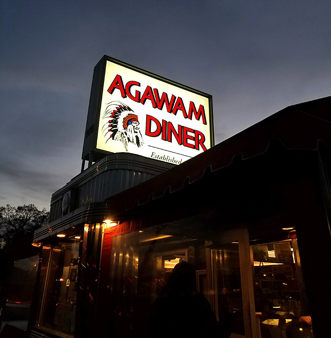 The iconic sign glows like a beacon in the twilight, guiding hungry souls to their comfort food destination.
