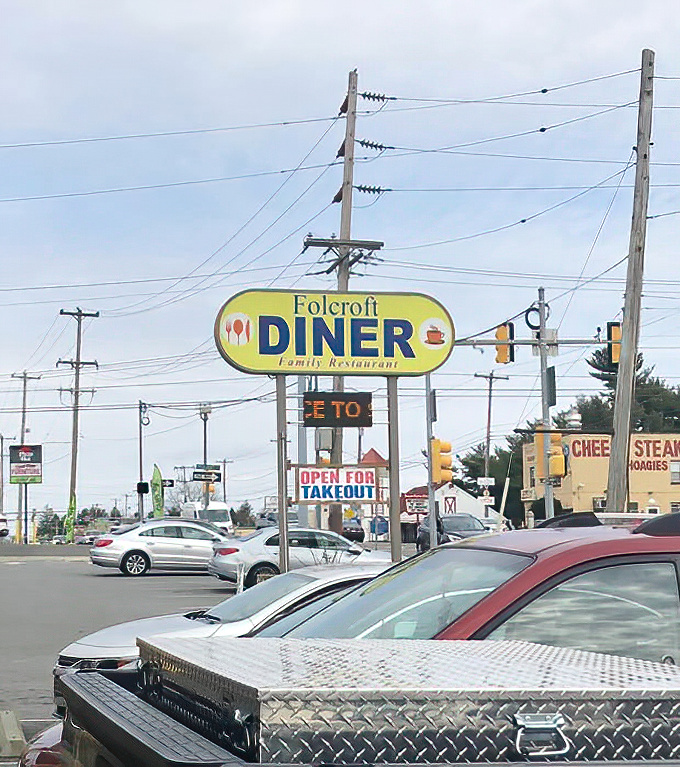The roadside sign stands tall, a beacon of hope for hungry travelers and locals alike. No GPS needed&mdash;just follow your appetite.