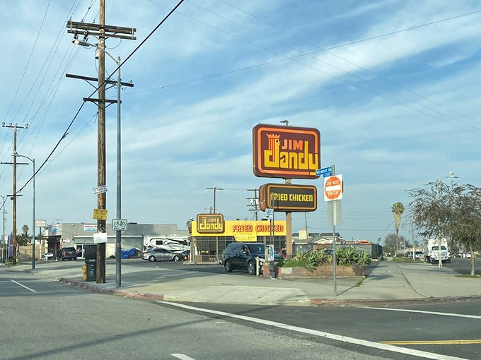 The corner sign stands proud like a beacon guiding hungry travelers to salvation, one drumstick at a time since forever.