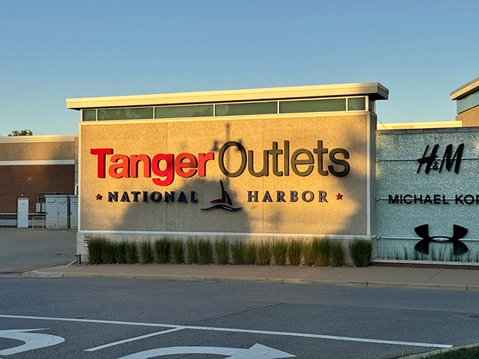 The golden hour glow on Tanger's entrance sign&mdash;a retail sunset that promises designer labels without designer prices just beyond those automatic doors.