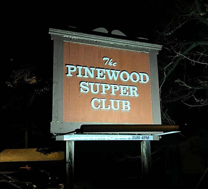 That illuminated sign cutting through the darkness acts like a beacon guiding hungry travelers toward their prime rib destiny.