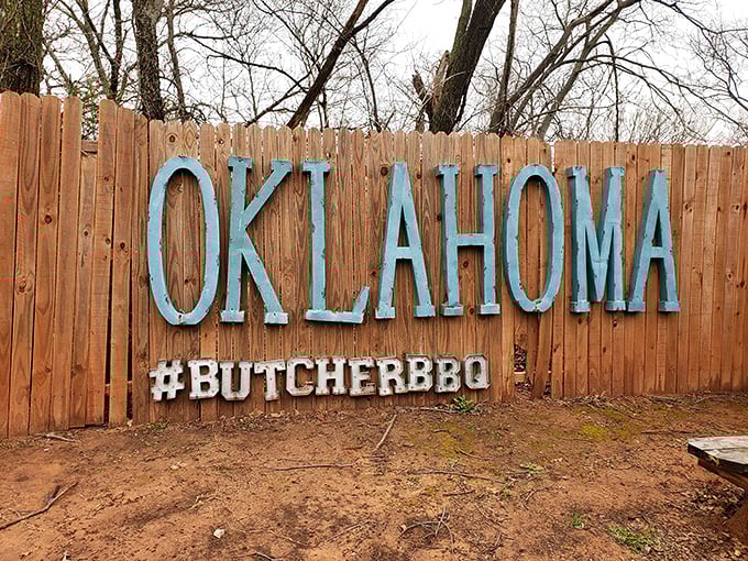 This wooden fence proudly proclaims its Oklahoma heritage&mdash;because great barbecue isn't just food, it's a statement of regional pride and tradition.