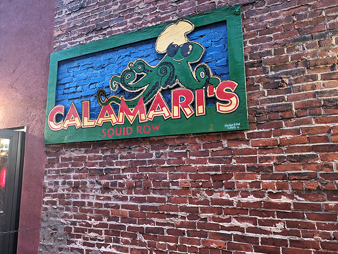 The cartoon squid grins knowingly from its brick wall perch. This sign has become an Erie landmark, guiding hungry souls to seafood salvation.