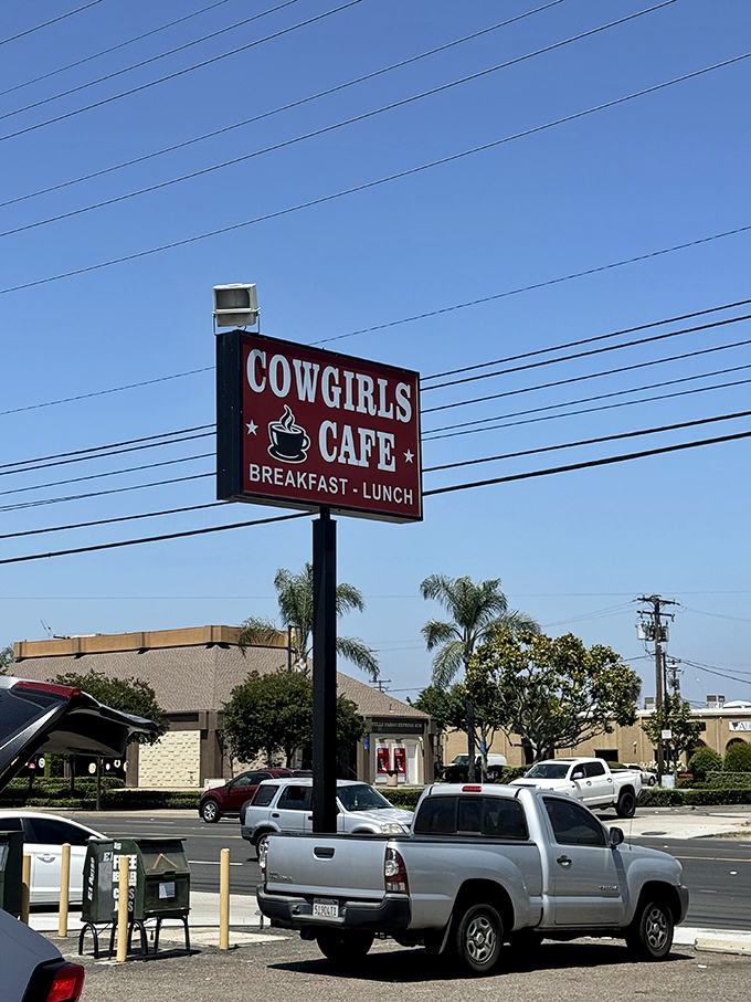 The iconic red sign stands as a beacon of breakfast hope along the Santa Ana skyline, promising good things to those who heed its call.