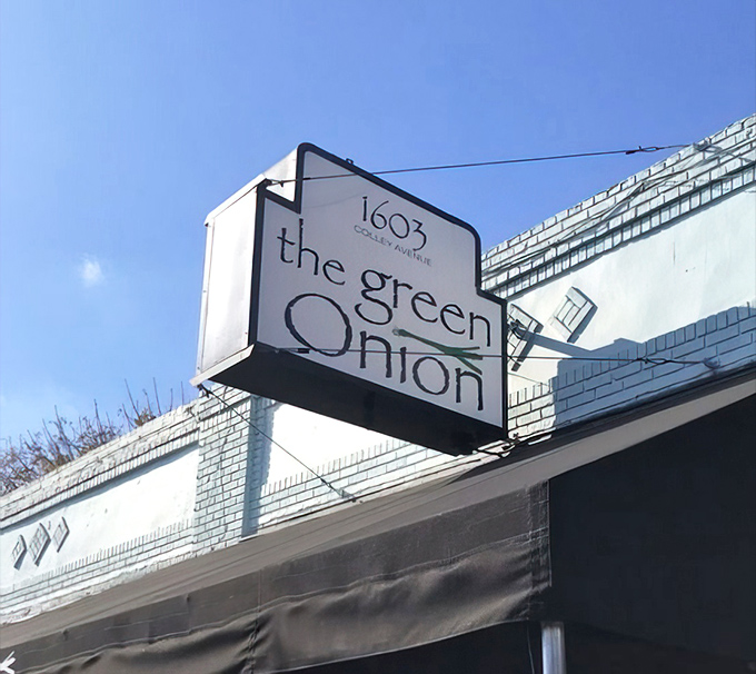 The Green Onion's vintage-style sign stands as a beacon for hungry travelers seeking seafood salvation in Norfolk's historic Ghent neighborhood.