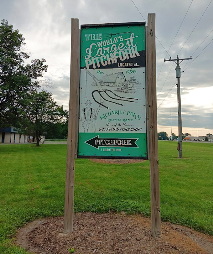 The vintage-style sign points travelers toward agricultural enormity&mdash;proof that sometimes the journey's best surprises come with excellent roadside advertising.