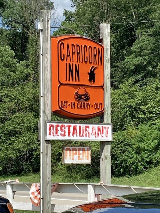 The bright orange sign stands like a beacon of burger hope along State Route 730, promising simple pleasures that deliver beyond expectations.