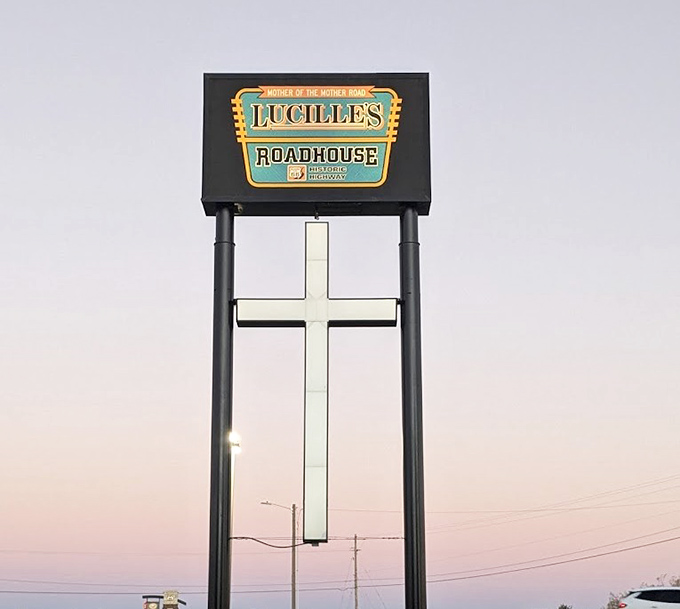 As day fades to dusk, the illuminated Lucille's sign stands as a beacon for hungry travelers seeking authentic roadside dining on the historic Mother Road.
