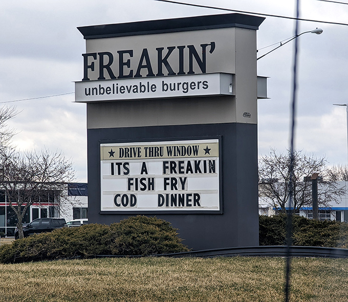 The marquee announces "IT'S A FREAKIN' FISH FRY"—because a place this confident with burgers probably excels at everything else too.