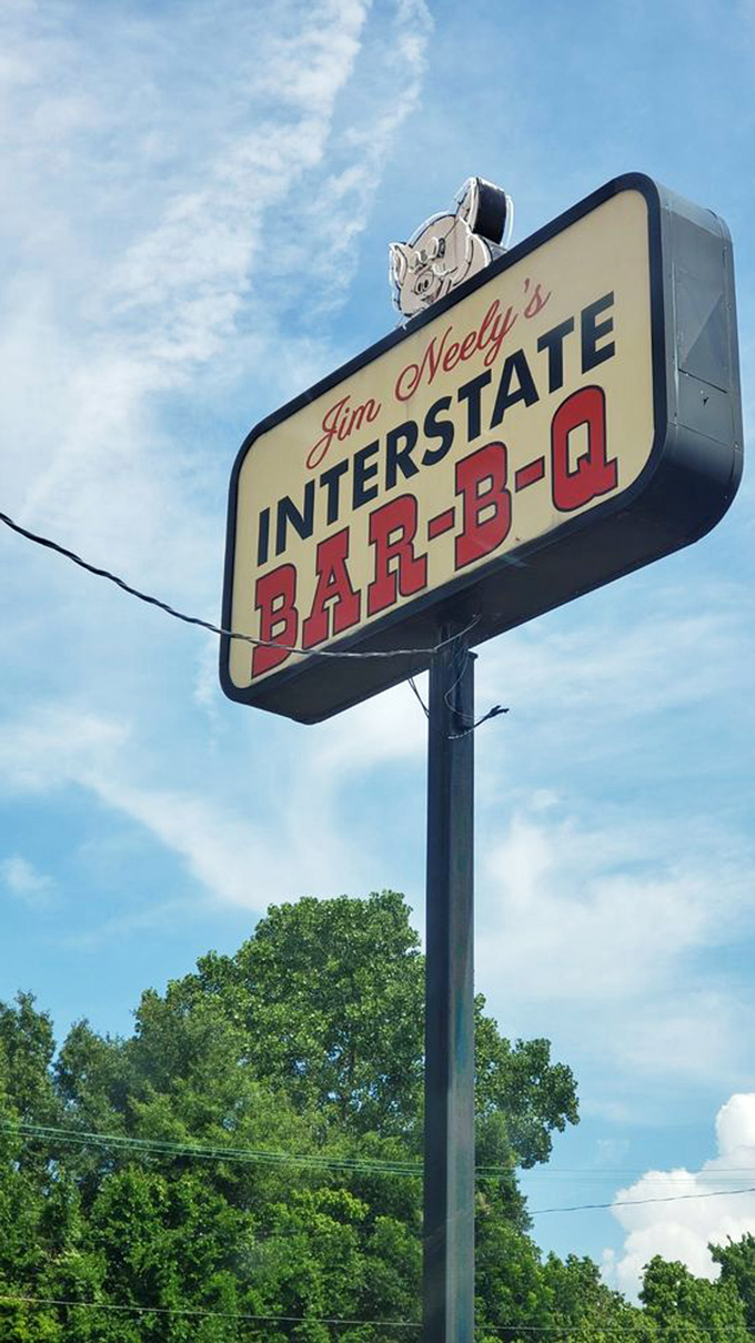 That vintage sign against the Memphis sky promises smoky delights to those wise enough to exit the highway for true barbecue bliss.