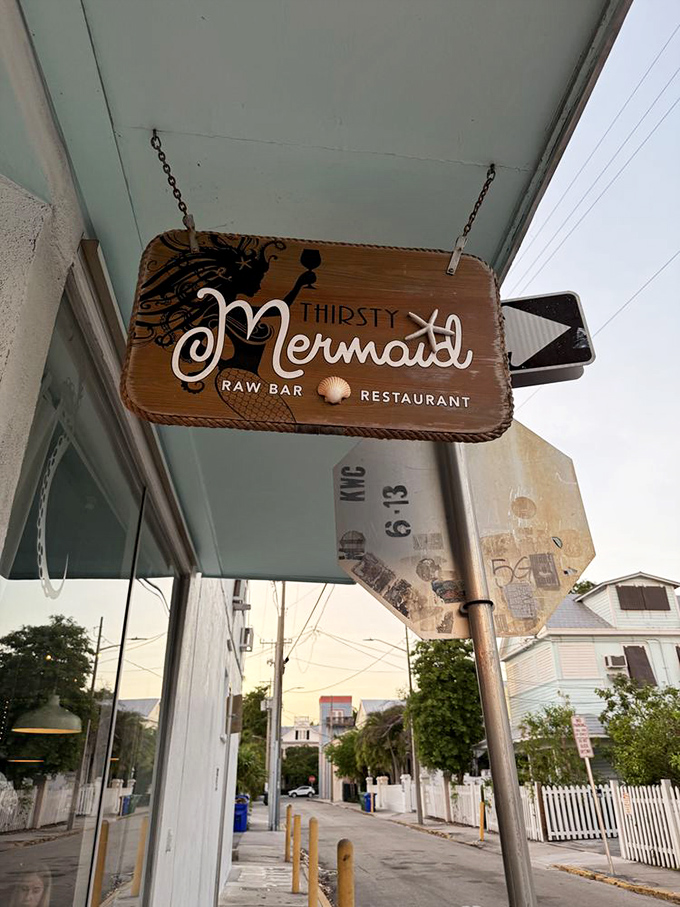 The wooden sign swings gently in the sea breeze, like a friendly wave saying "psst, the good stuff is in here."