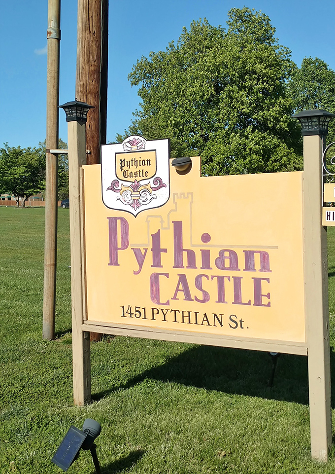 The cheerful yellow sign stands in stark contrast to the stone fortress behind it, like a friendly greeter saying, "Yes, we're an actual castle in Missouri. Come on in!"