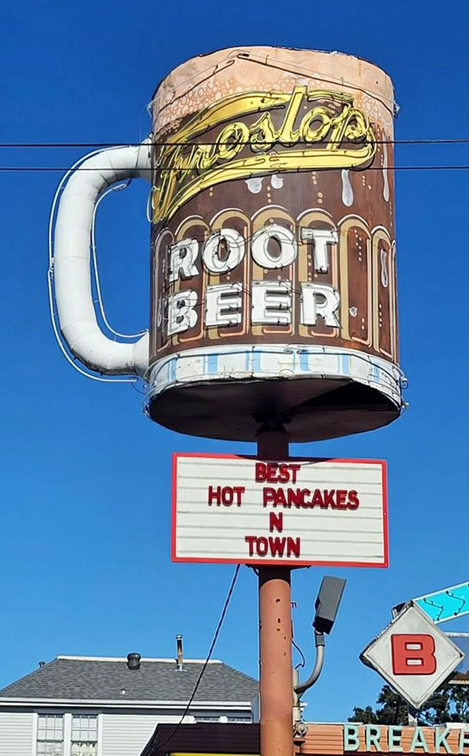 That magnificent mug against the blue Louisiana sky, proudly announcing "BEST HOT PANCAKES N TOWN"—a promise they deliver on daily.