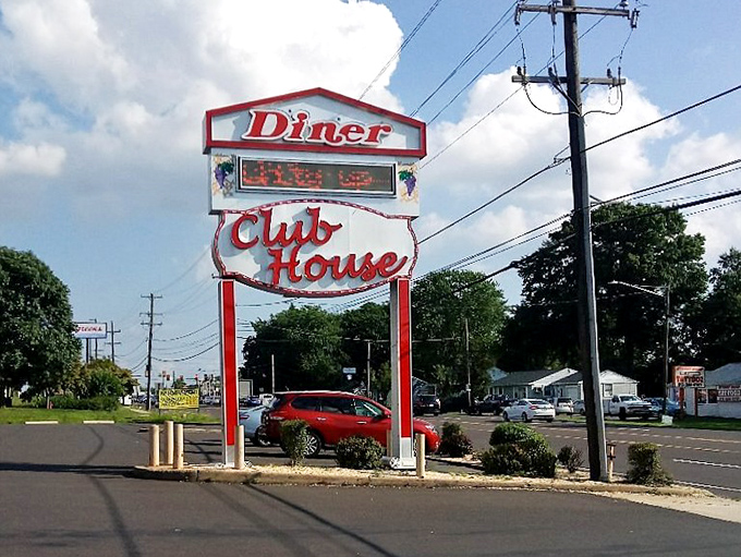 The roadside sign stands tall, a retro beacon guiding hungry travelers to what might be the best meal they'll have all day.
