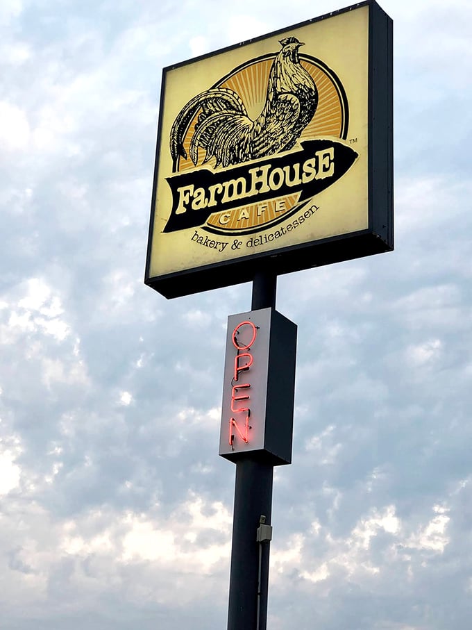 The iconic rooster sign stands tall against cloudy skies, like a farmyard sentinel guarding the promised land of breakfast delights below.