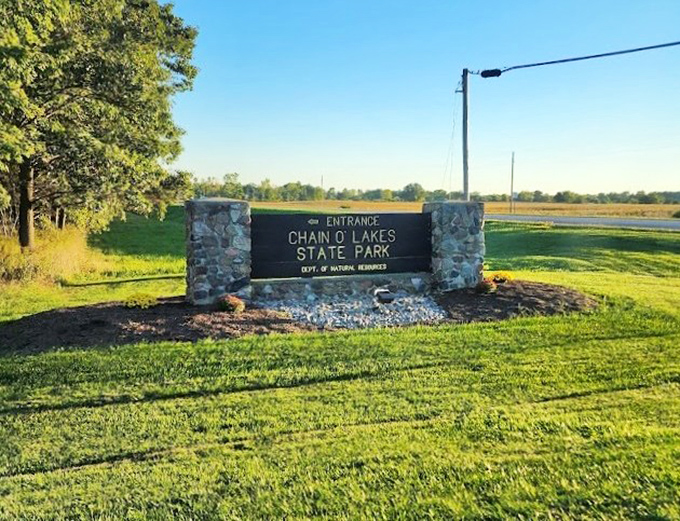 The gateway to adventure doesn't need to be flashy. This understated entrance sign promises natural wonders that far exceed its modest appearance.