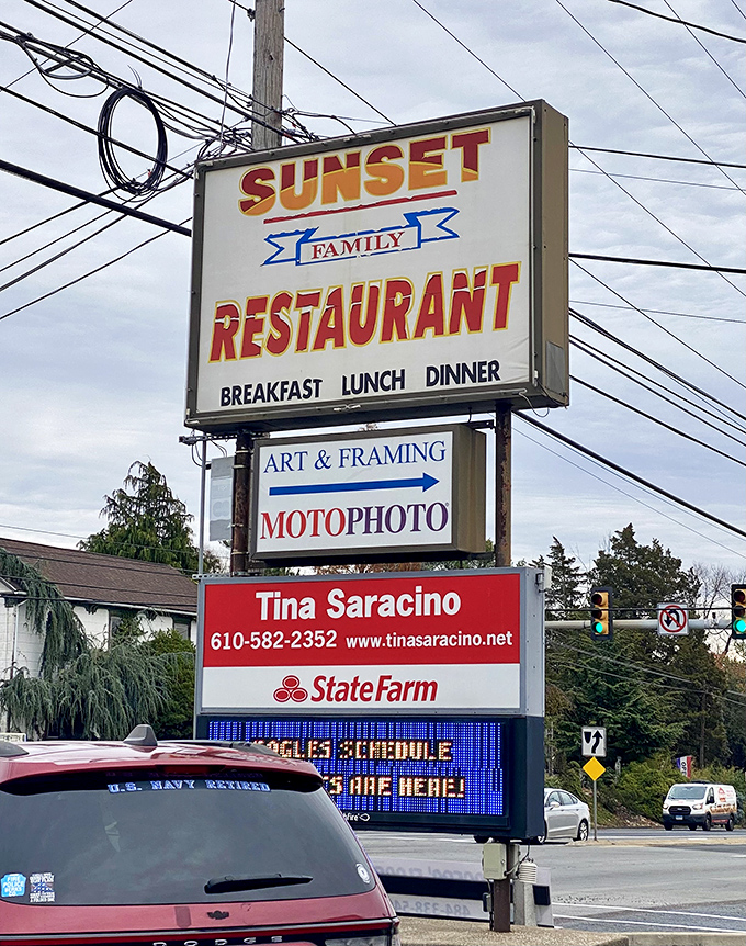 The sign stands tall like a beacon for breakfast seekers, promising family dining from dawn to dinner.