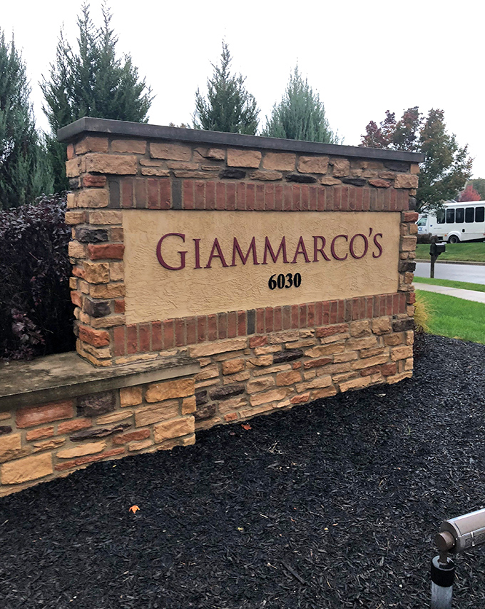 The stone entrance sign stands as a landmark of promised culinary pleasure &ndash; like a delicious X marking the spot on your gastronomic treasure map.