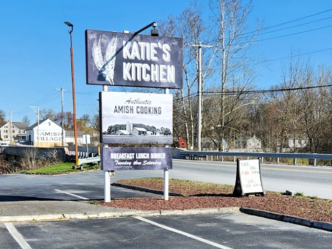 The roadside sign stands proud against blue Pennsylvania skies, a beacon for hungry travelers seeking authentic Amish cooking.
