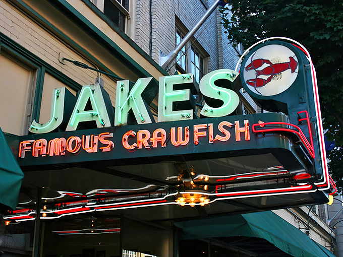 As evening falls, Jake's neon sign becomes a lighthouse for hungry souls, beckoning with the promise of crawfish and cocktails in downtown Portland.