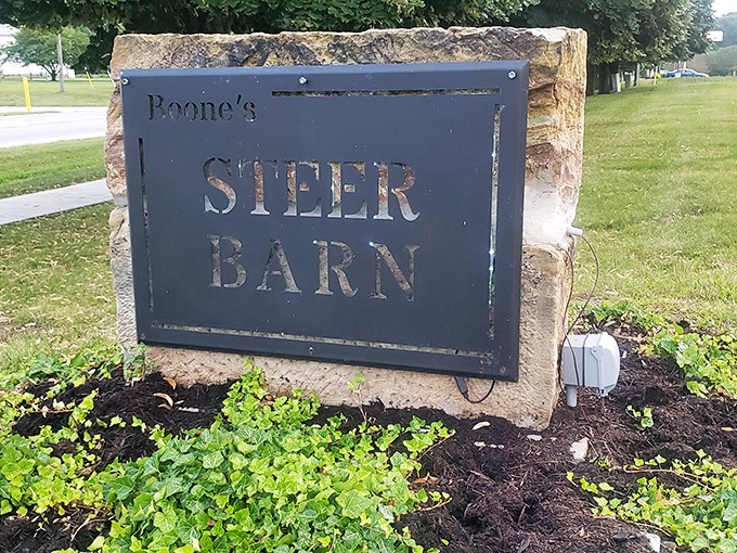 The stone-mounted sign stands as a humble guardian at the property's edge &ndash; no flashy neon needed when your reputation speaks volumes.