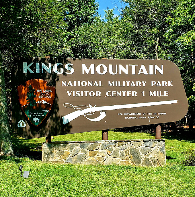 The entrance sign welcomes you to hallowed ground where history and nature converge. Your adventure begins exactly one mile ahead.
