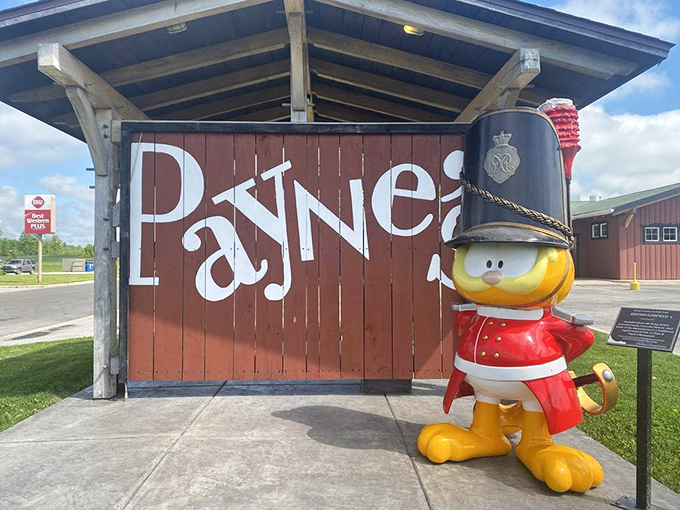 Garfield's British cousin? This whimsical guard in royal regalia stands watch at Payne's entrance, setting the tone for the delightful experience within.