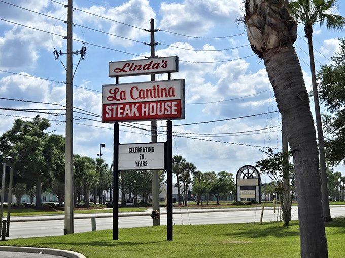 The vintage roadside sign stands as a beacon of hope for the hungry, promising 70+ years of steak expertise under the Florida sky.