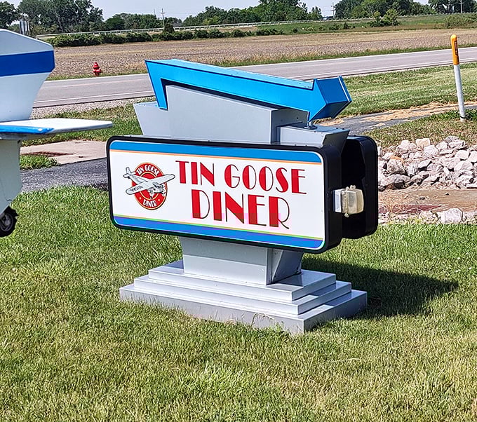 The roadside sign stands as a retro landmark, guiding hungry travelers to this chrome oasis like a delicious North Star of comfort food.