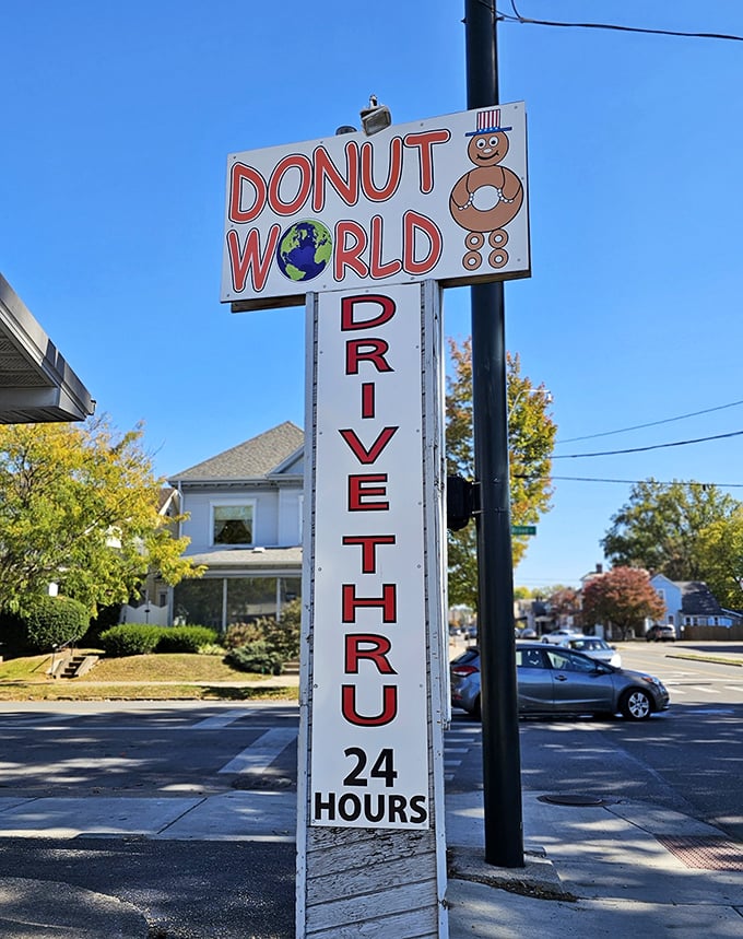 The iconic Donut World sign stands tall against the blue Ohio sky, its 24-hour promise a beacon of hope for late-night sweet tooth emergencies.