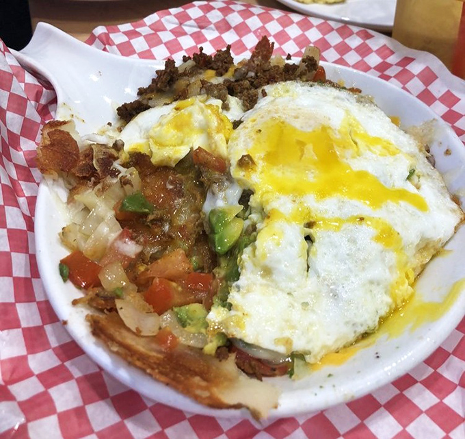 A skillet breakfast that's basically a treasure hunt with a fork. Each bite reveals new combinations of flavors hiding beneath those perfectly cooked eggs.