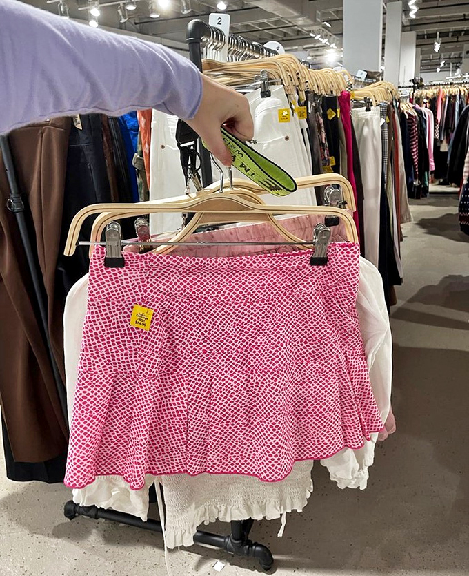 Someone's holding up a pink gingham skirt that's absolutely begging for a second chance at summer picnics and good times.