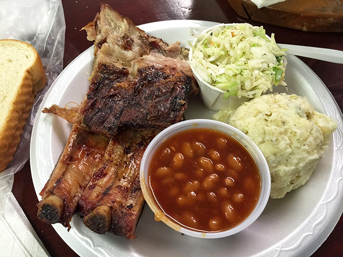 The classic small rib plate - a holy trinity of ribs, beans, and sides that proves heaven exists and it smells like hickory smoke.