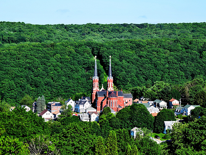 Twin spires reach skyward from this magnificent church, creating an iconic silhouette against the lush backdrop of Pennsylvania's forests.